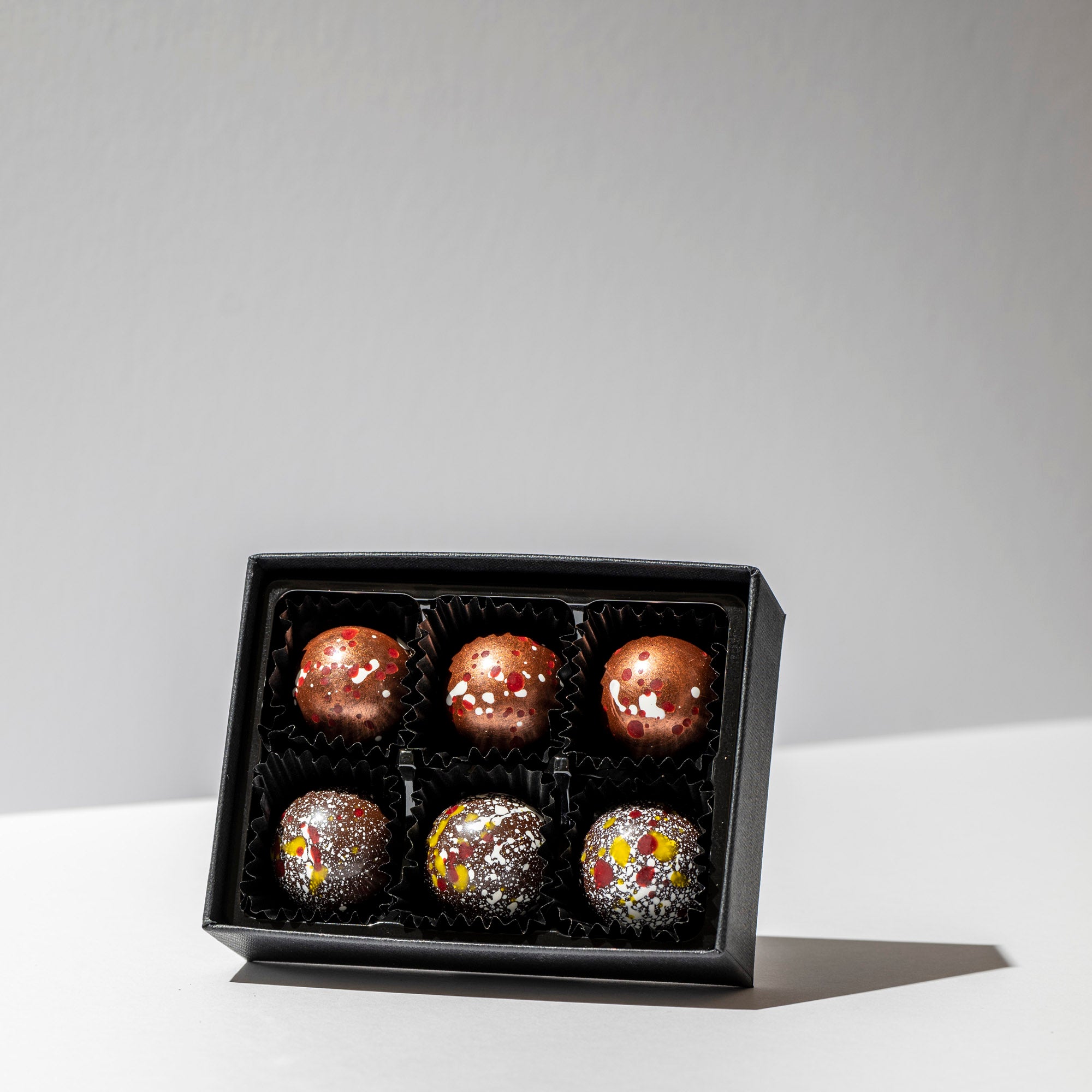 Dark chocolate hand decorated truffles with a Spiced Rum ganache ...